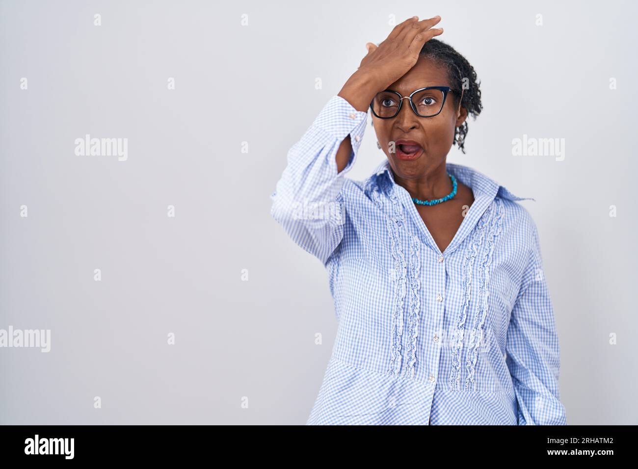 African woman with dreadlocks standing over white background wearing ...