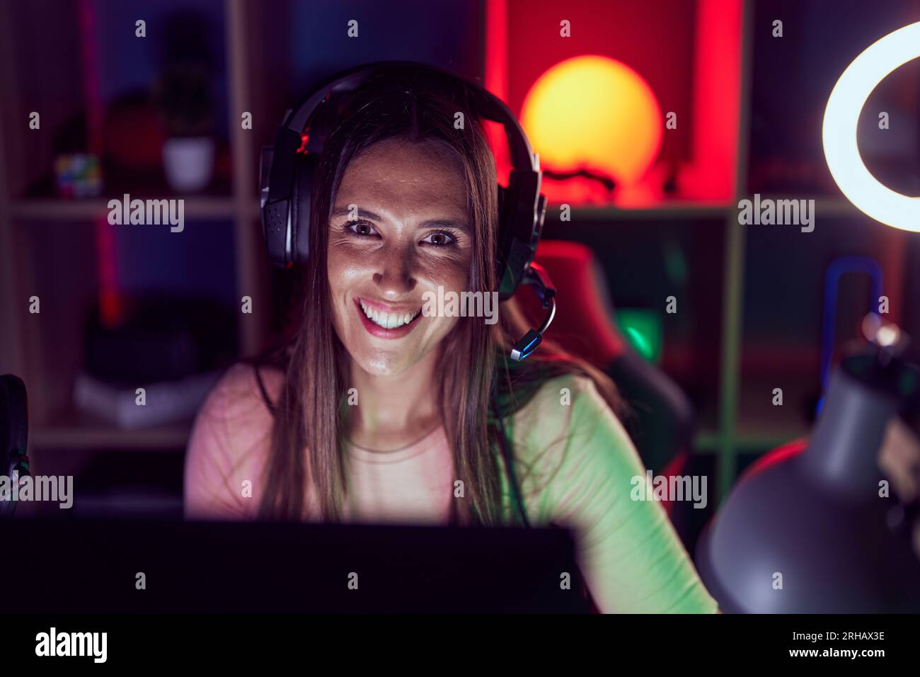 Young beautiful hispanic woman streamer playing video game using ...