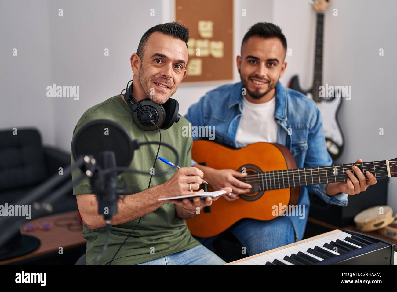 Two men musicians composing song playing classical guitar at music ...