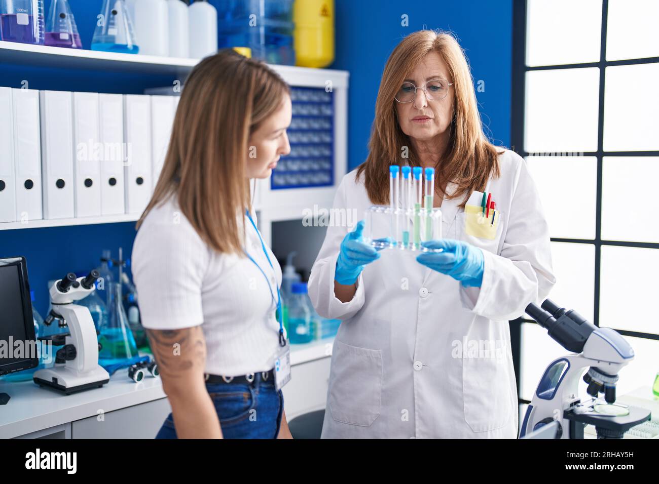 Mother and daughter scientists holding test tubes at laboratory Stock ...