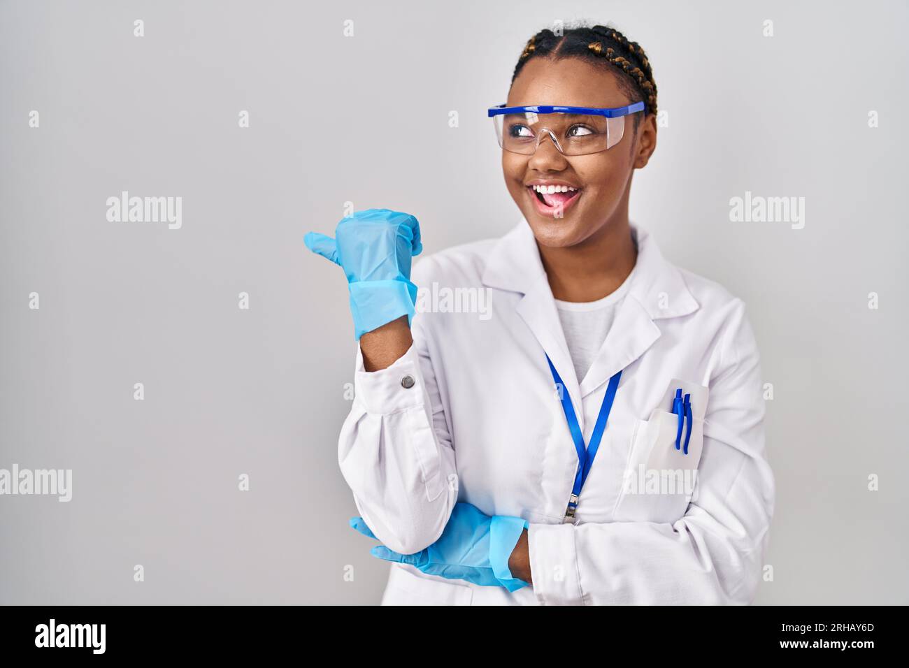 African american woman with braids wearing scientist robe smiling with ...