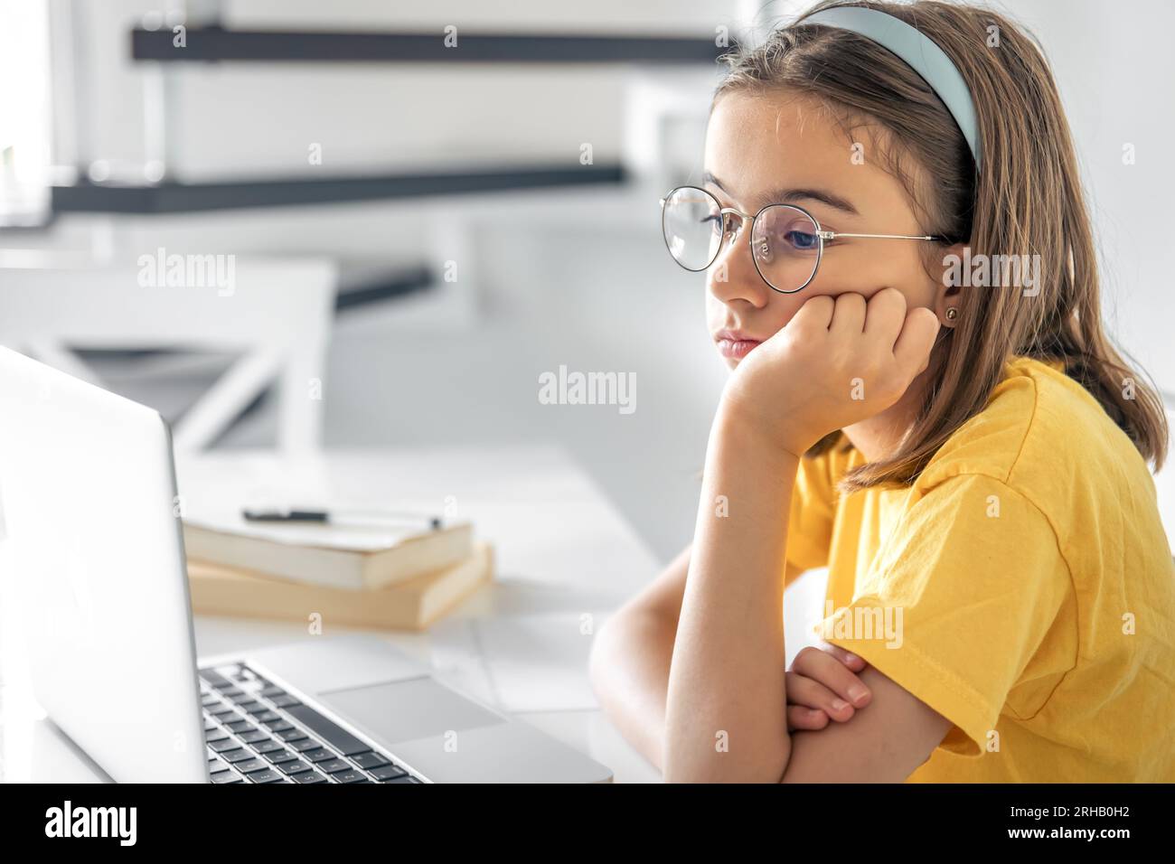 Exhausted schooler girl suffering from doing homework, tired from ...