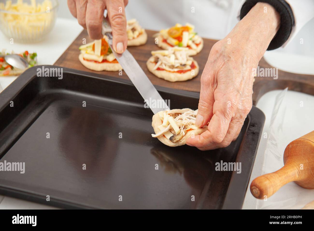 Ready to be baked mini pizzas. Delicious home made mini pizzas preparation Stock Photo - Alamy