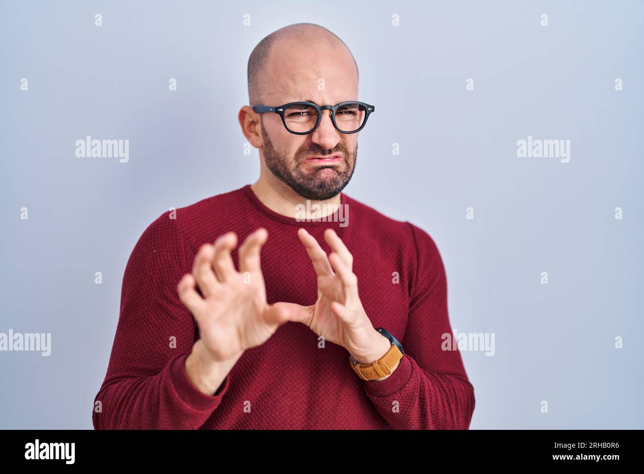 Young bald man with beard standing over white background wearing ...
