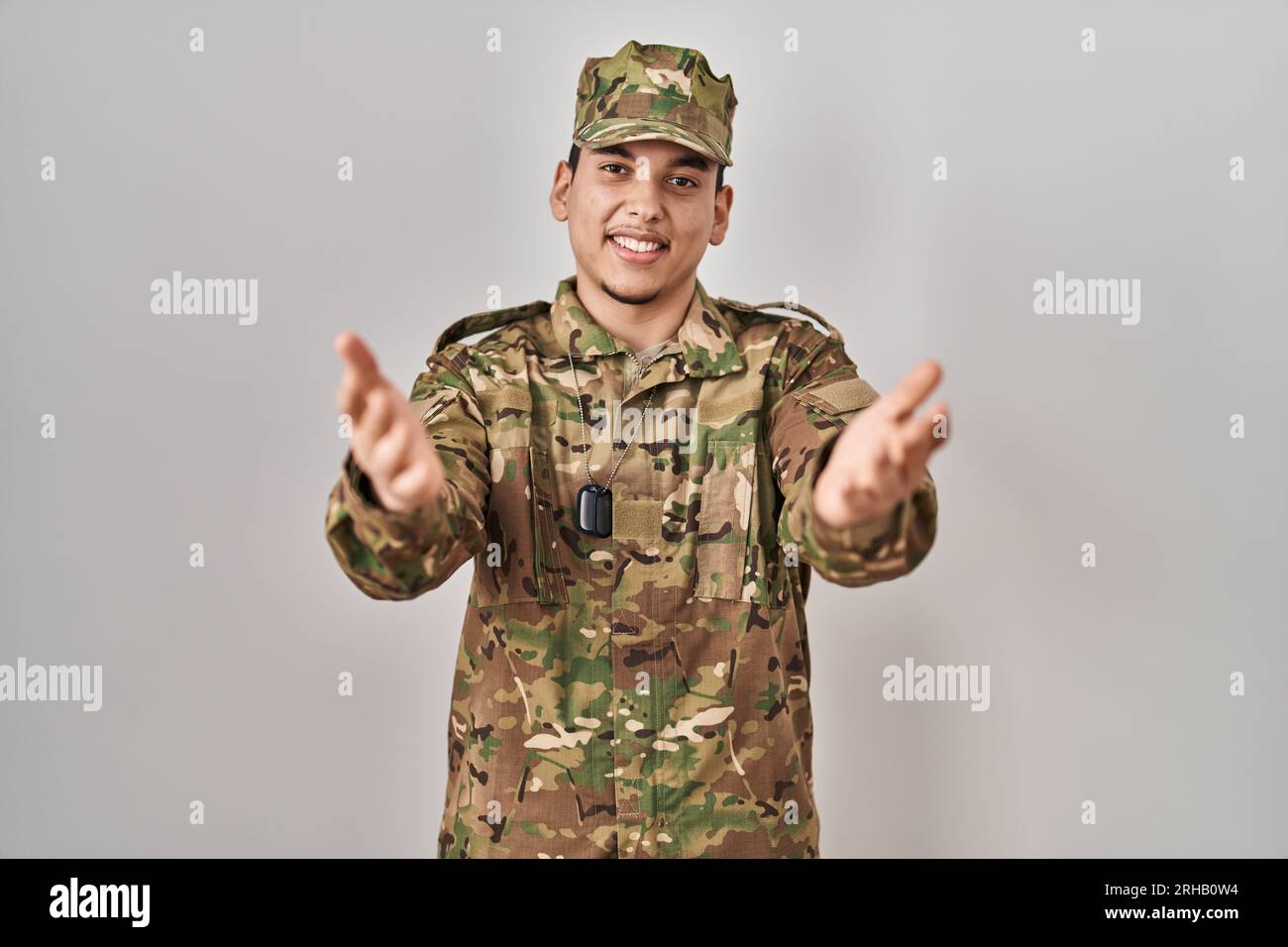 Young arab man wearing camouflage army uniform smiling cheerful ...