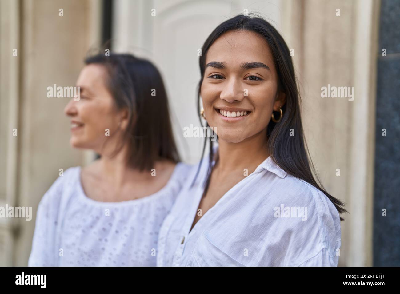 Two Women Mother And Daughter Smiling Confident Standing Together At