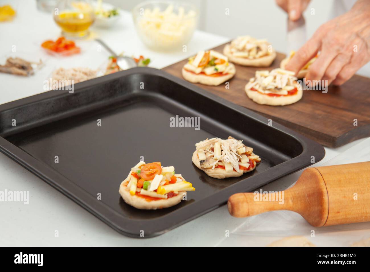Ready to be baked mini pizzas. Delicious home made mini pizzas preparation Stock Photo - Alamy