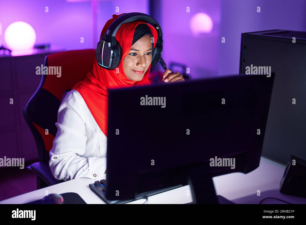 Young beautiful woman streamer playing video game using computer at ...