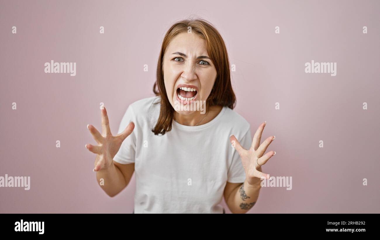 Young woman screaming loudly over isolated pink background Stock Photo ...