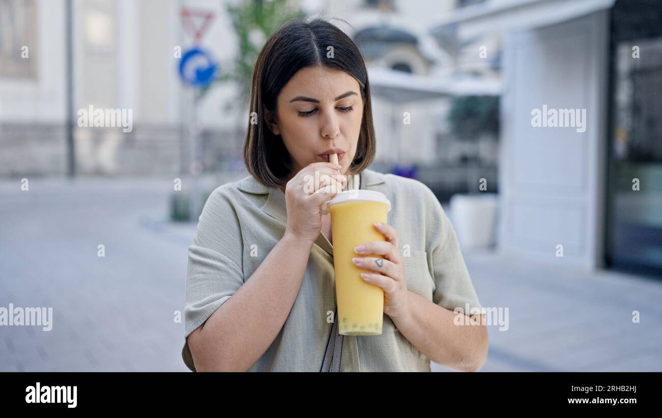 Young beautiful hispanic woman drinking bubble tea in the streets of Vienna Stock Photo - Alamy