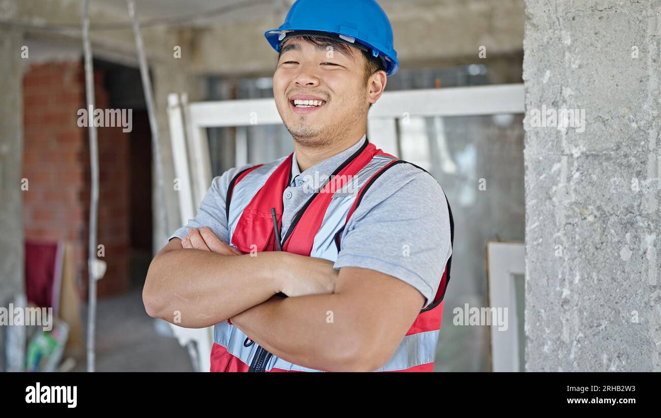 builder smiling confident standing with arms crossed gesture at ...