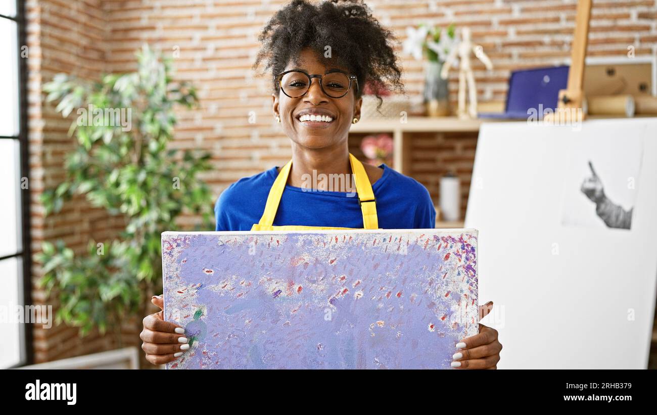 African american woman artist smiling confident holding draw at art ...
