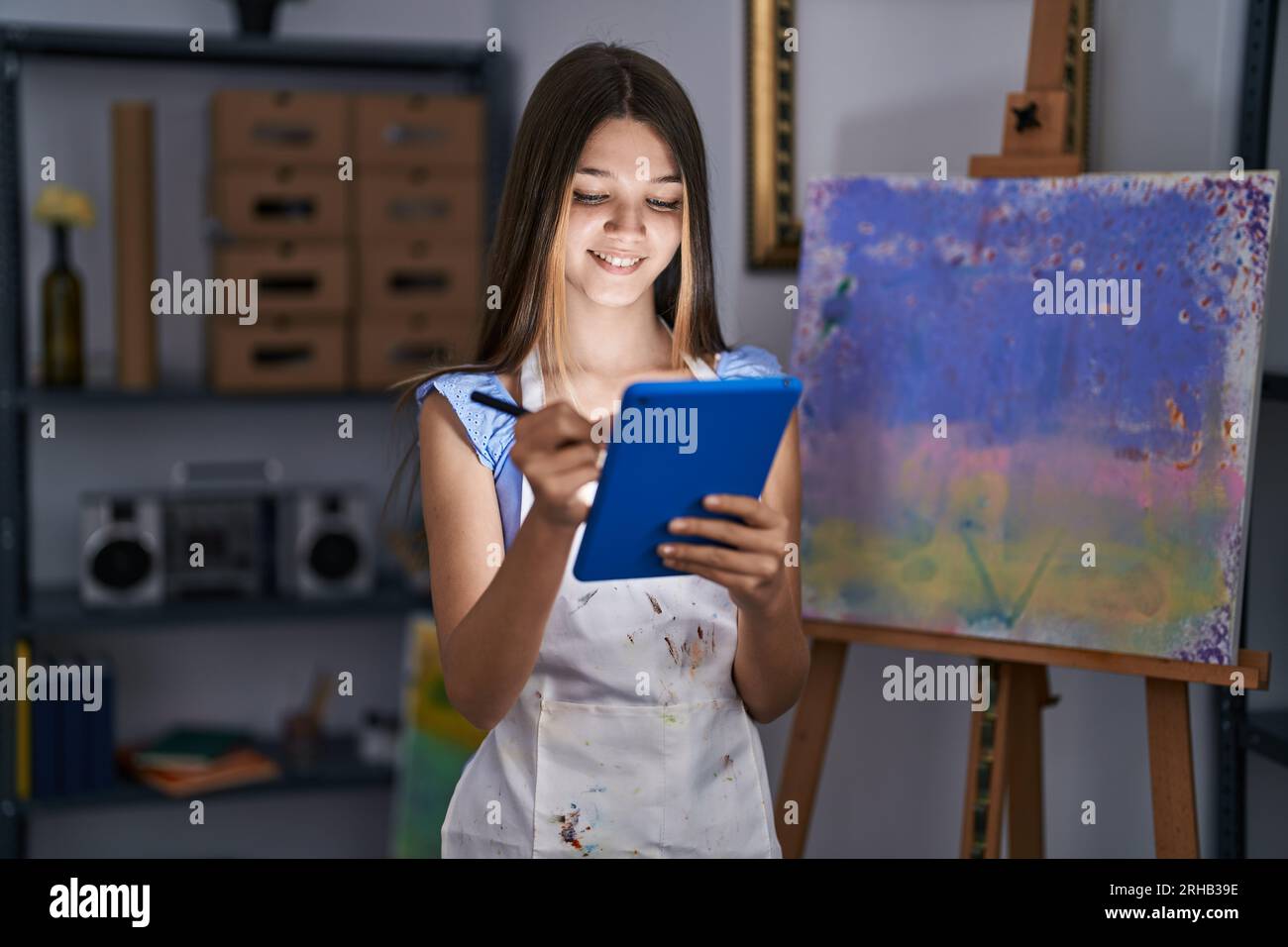 Adorable girl artist using touchpad drawing at art studio Stock Photo ...