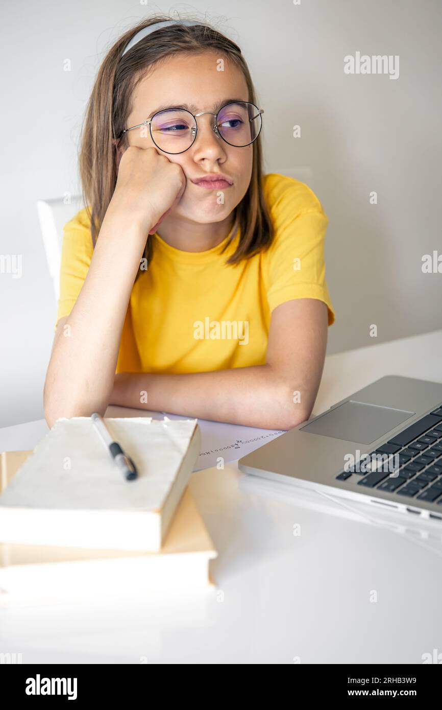 Exhausted schooler girl suffering from doing homework, tired from ...