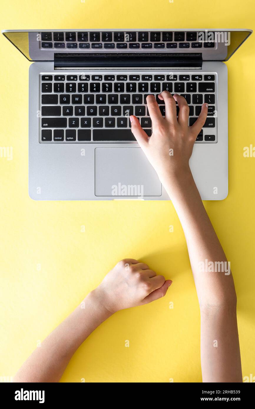 Typing kid in yellow hi-res stock photography and images - Alamy