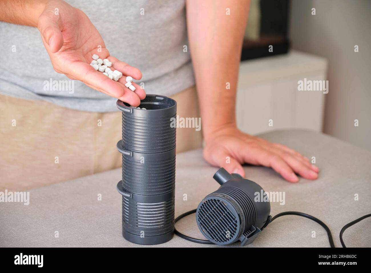 Man hand putting new aquarium bio filter medium for the filter bacteria ...
