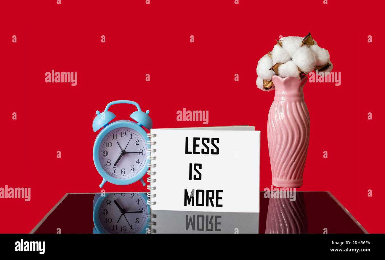 Text Less is more scale concept on red and black background Stock Photo ...