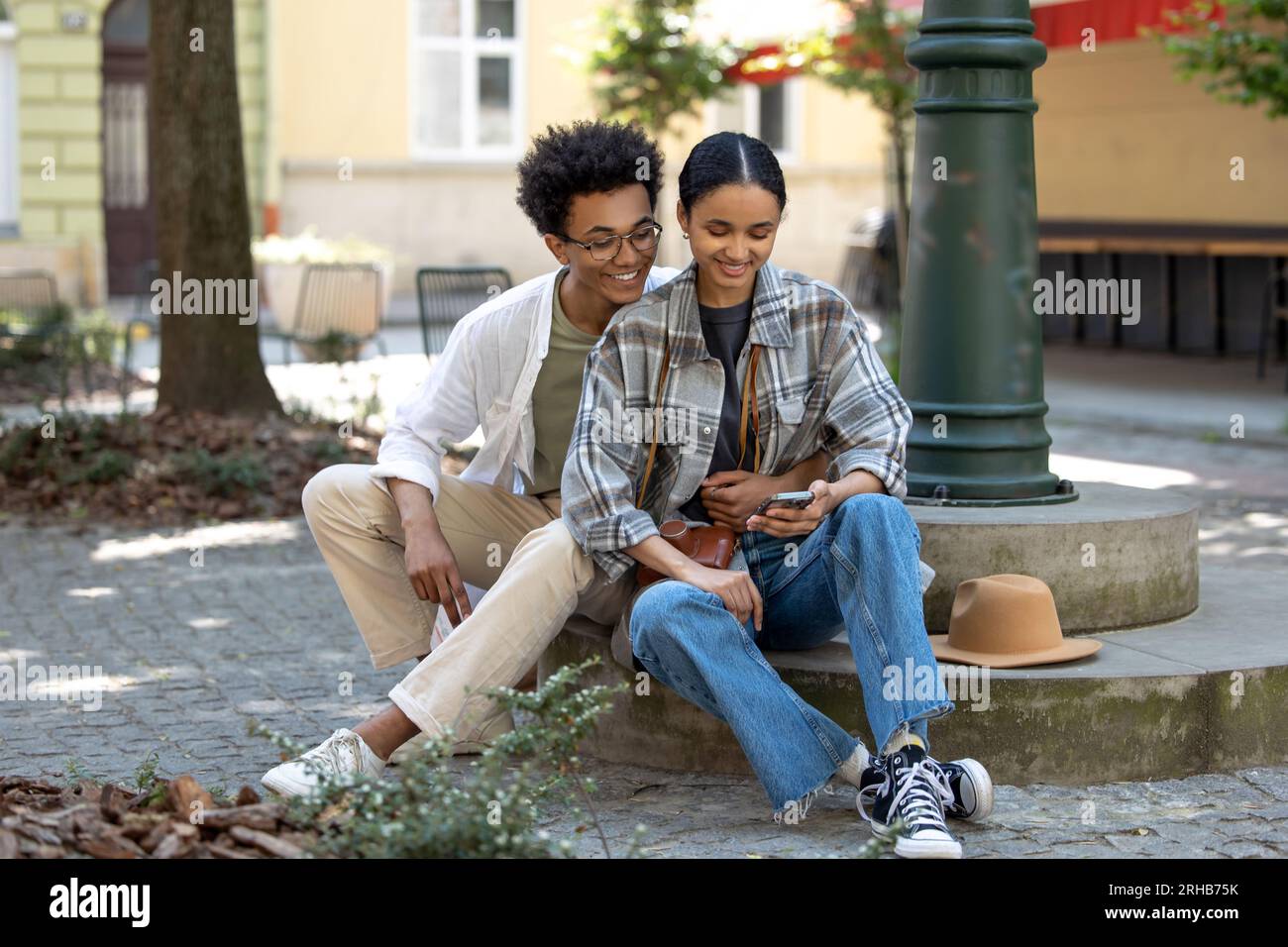 Young people sitting together and looking happy and contented Stock ...