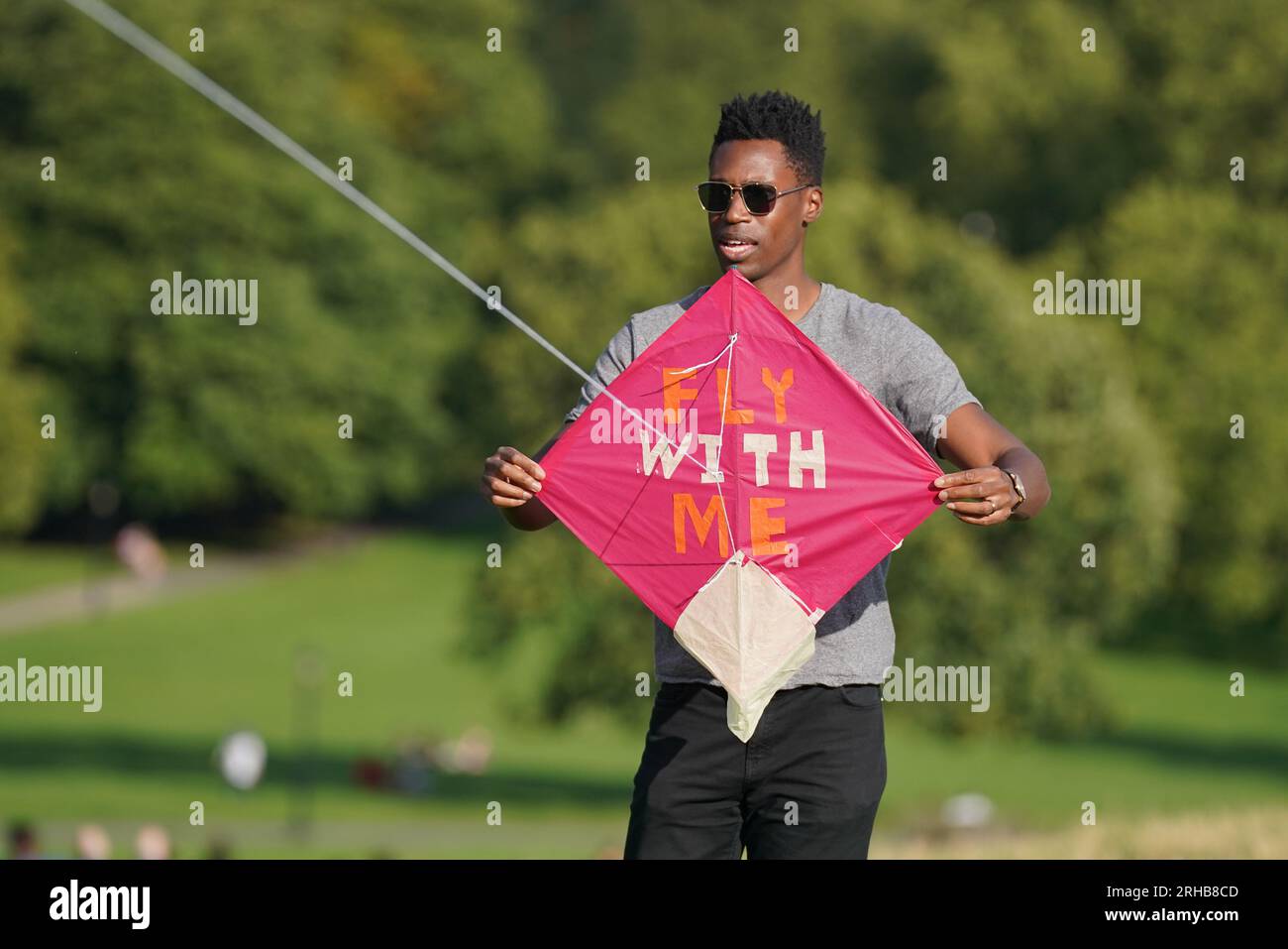 People taking part in an Afghan kite-flying event at a park in London ...