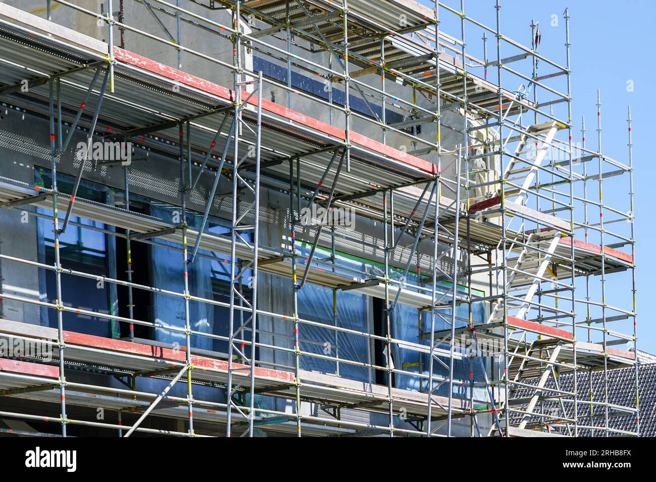 Modular scaffold construction frame with around house facade on blue ...