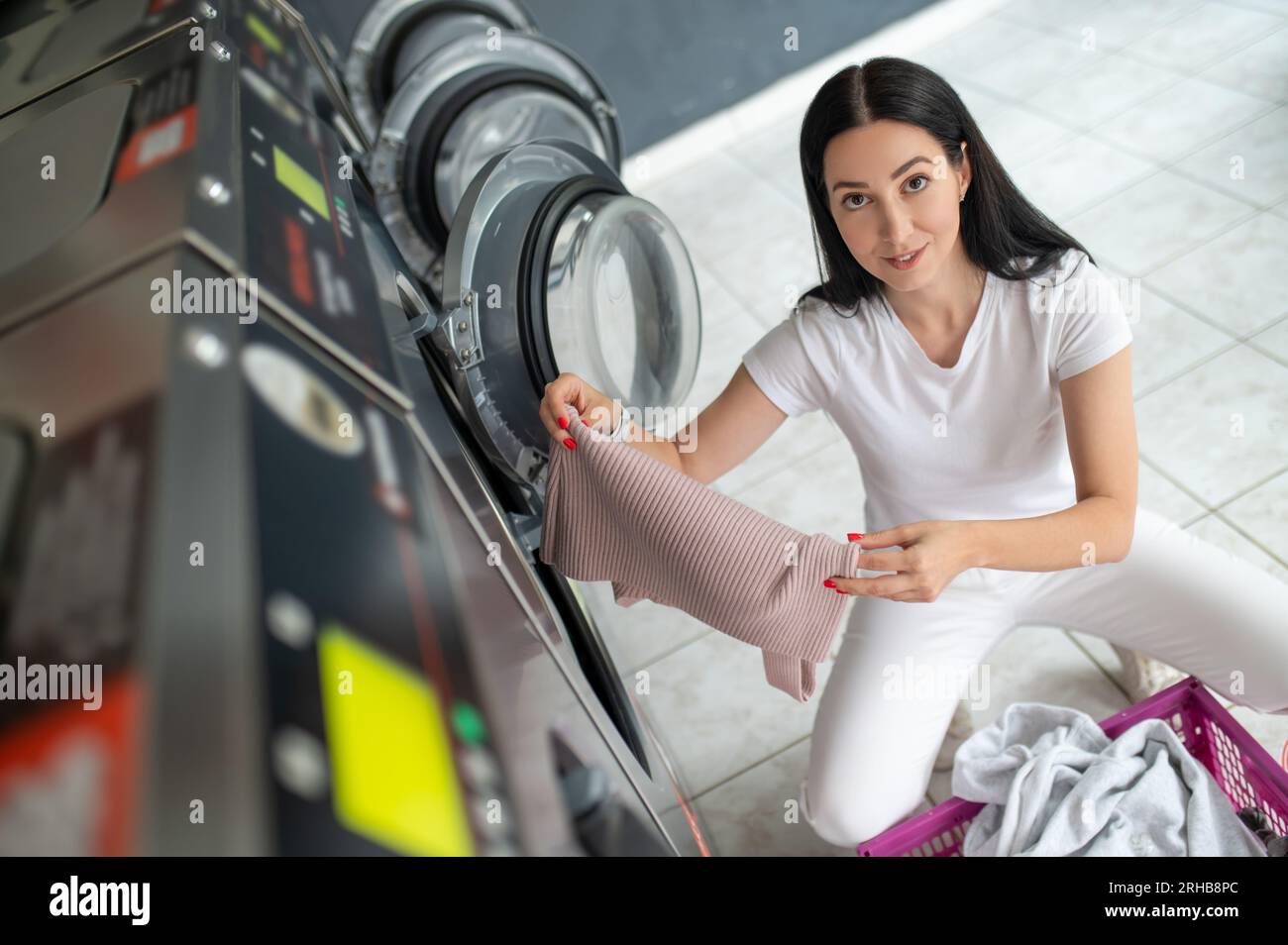Woman sorting laundry washing machine hi-res stock photography and images - Alamy