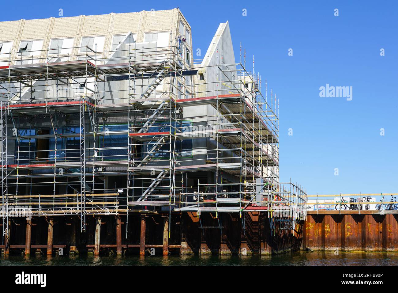 Reconstruction works of a house built on metal piles by the water ...