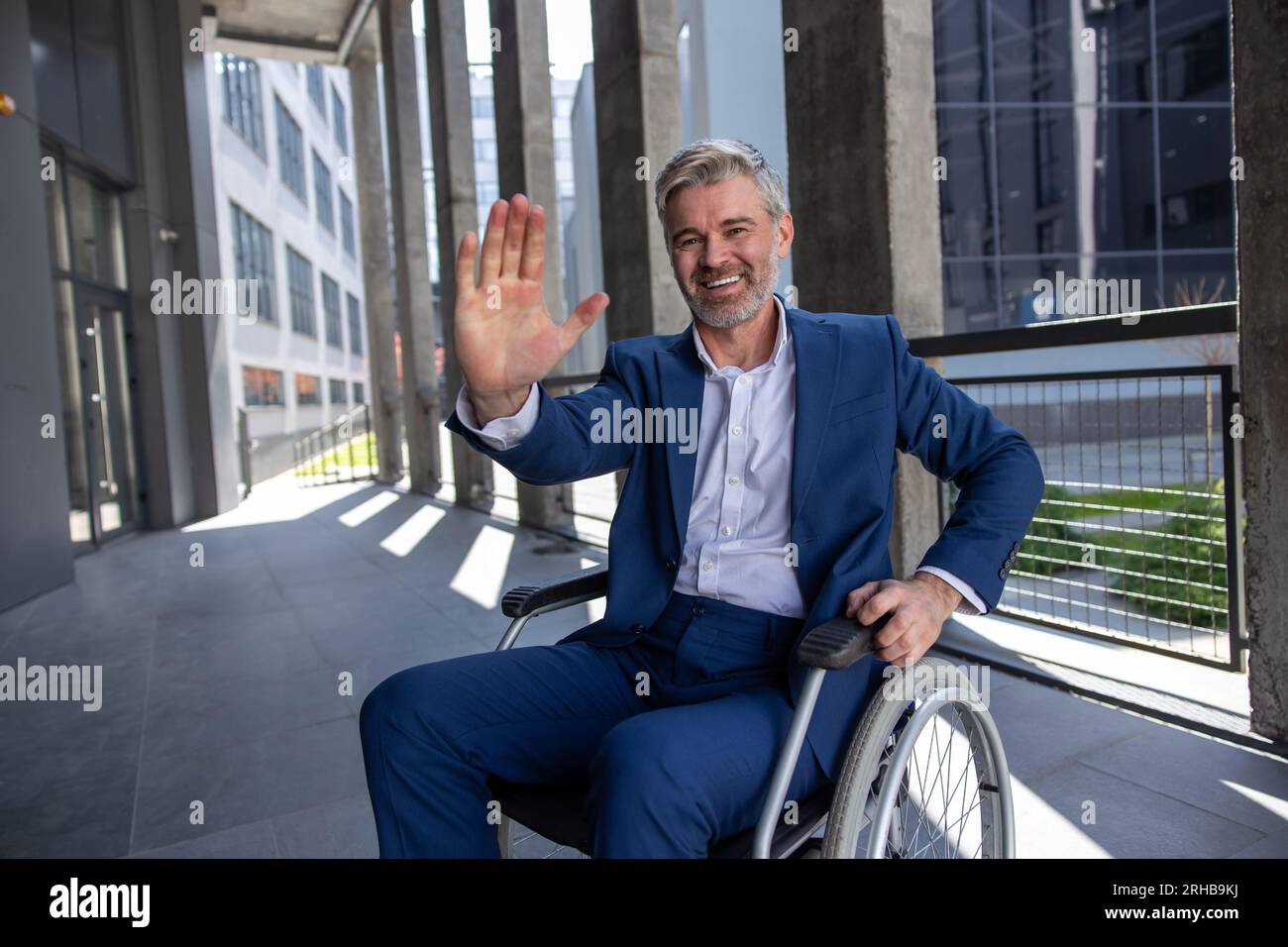 Gray haired disabled man wearing official style suit in wheelchair ...