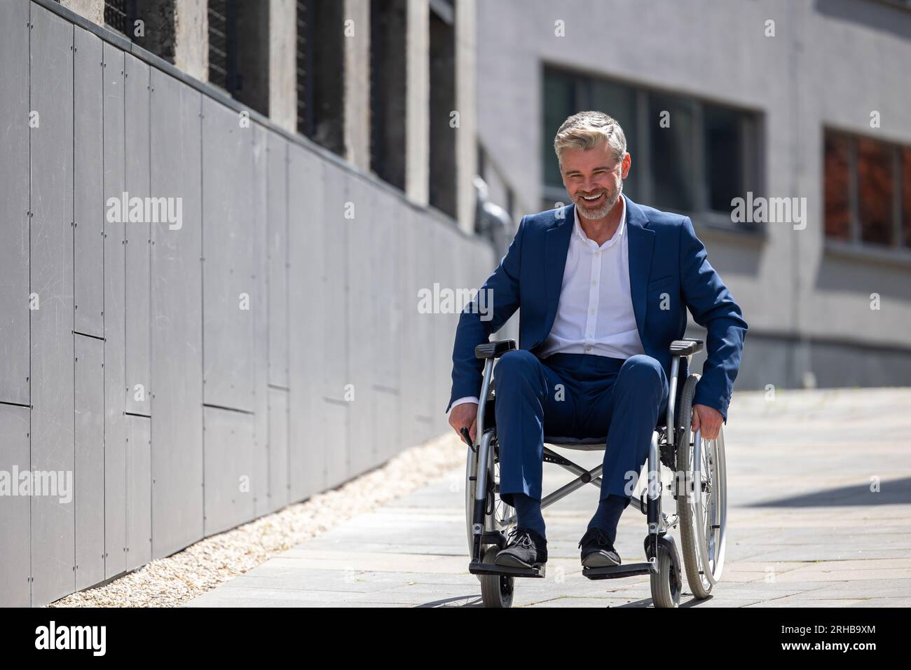 Disabled handsome man on wheelchair outdoor Stock Photo - Alamy