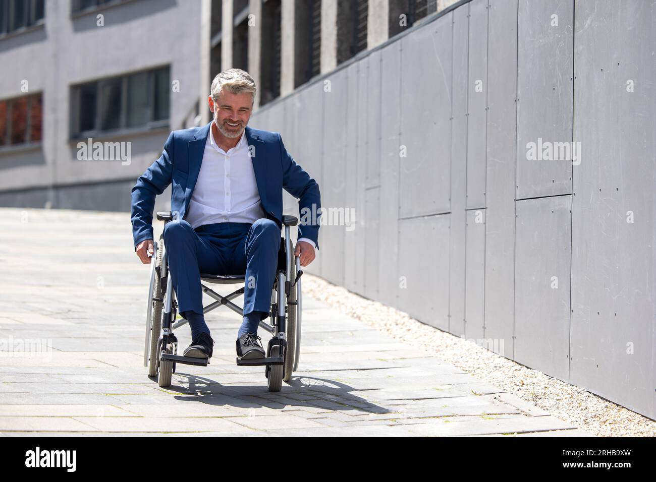 Disabled handsome man on wheelchair outdoor Stock Photo - Alamy