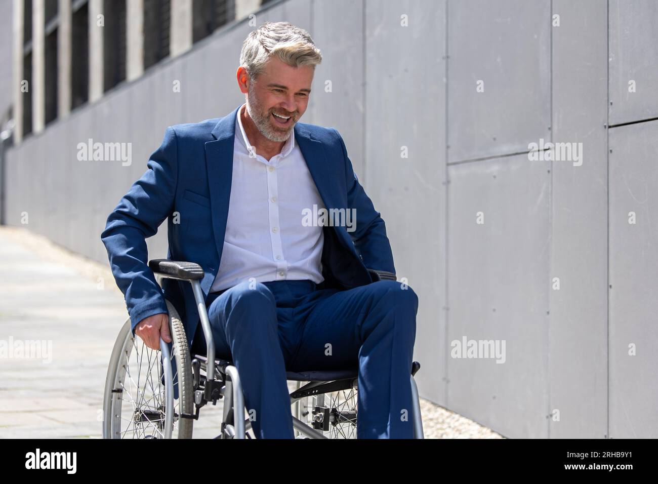 Disabled handsome man on wheelchair outdoor Stock Photo - Alamy