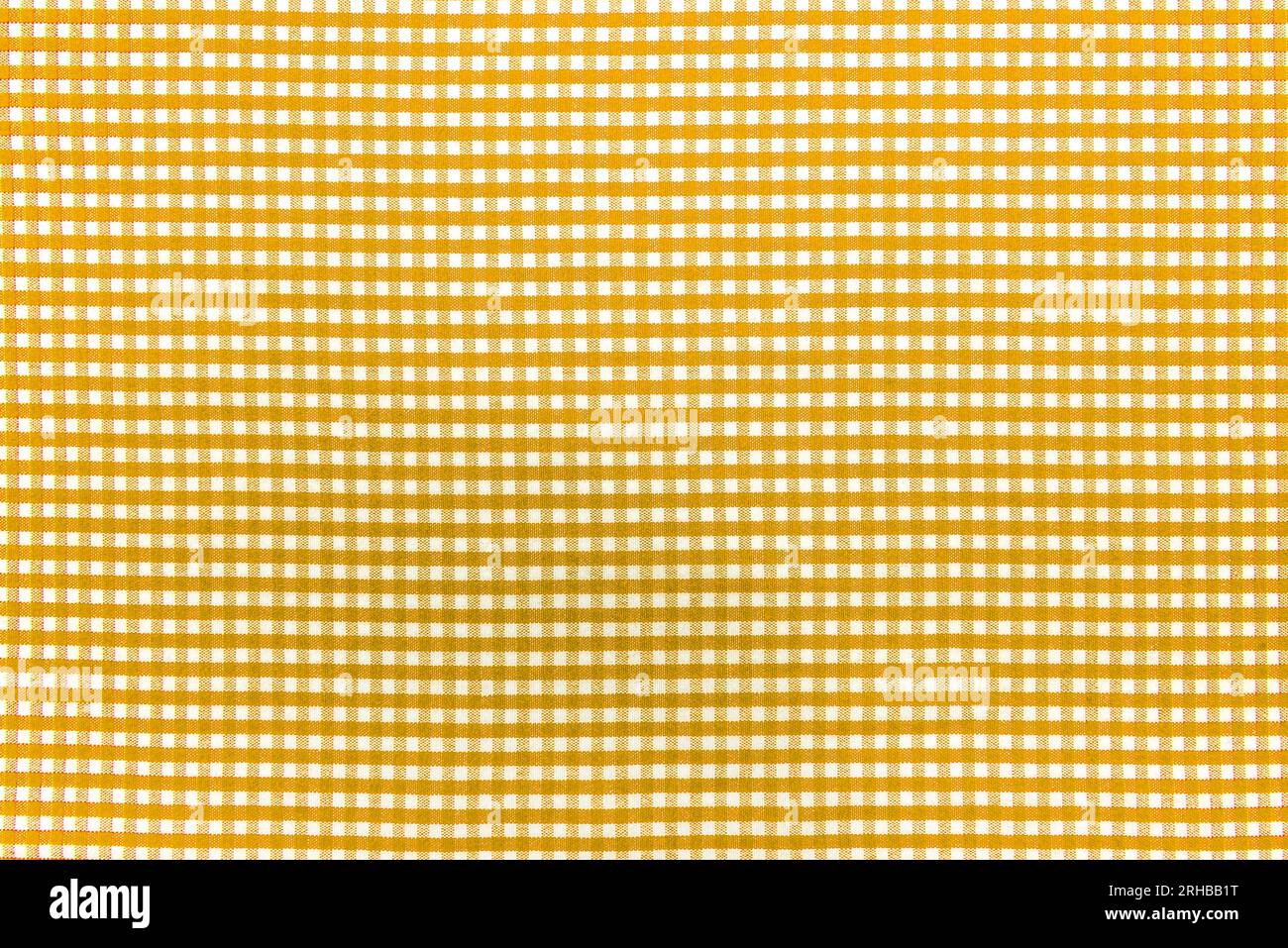 The texture of linen fabric in a large cell of yellow and white ...