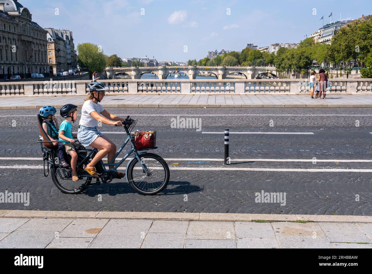 Paris, FR - 31 August 2022: Woman riding a bicycle on Pont au Change ...