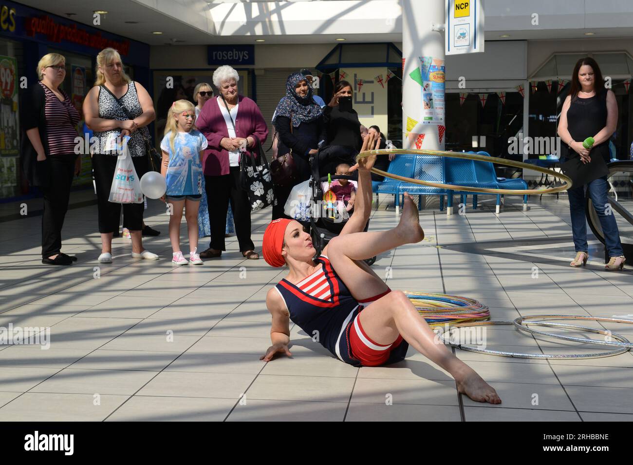Hula hoop artists performing at shopping centre Britain, Uk Stock Photo ...