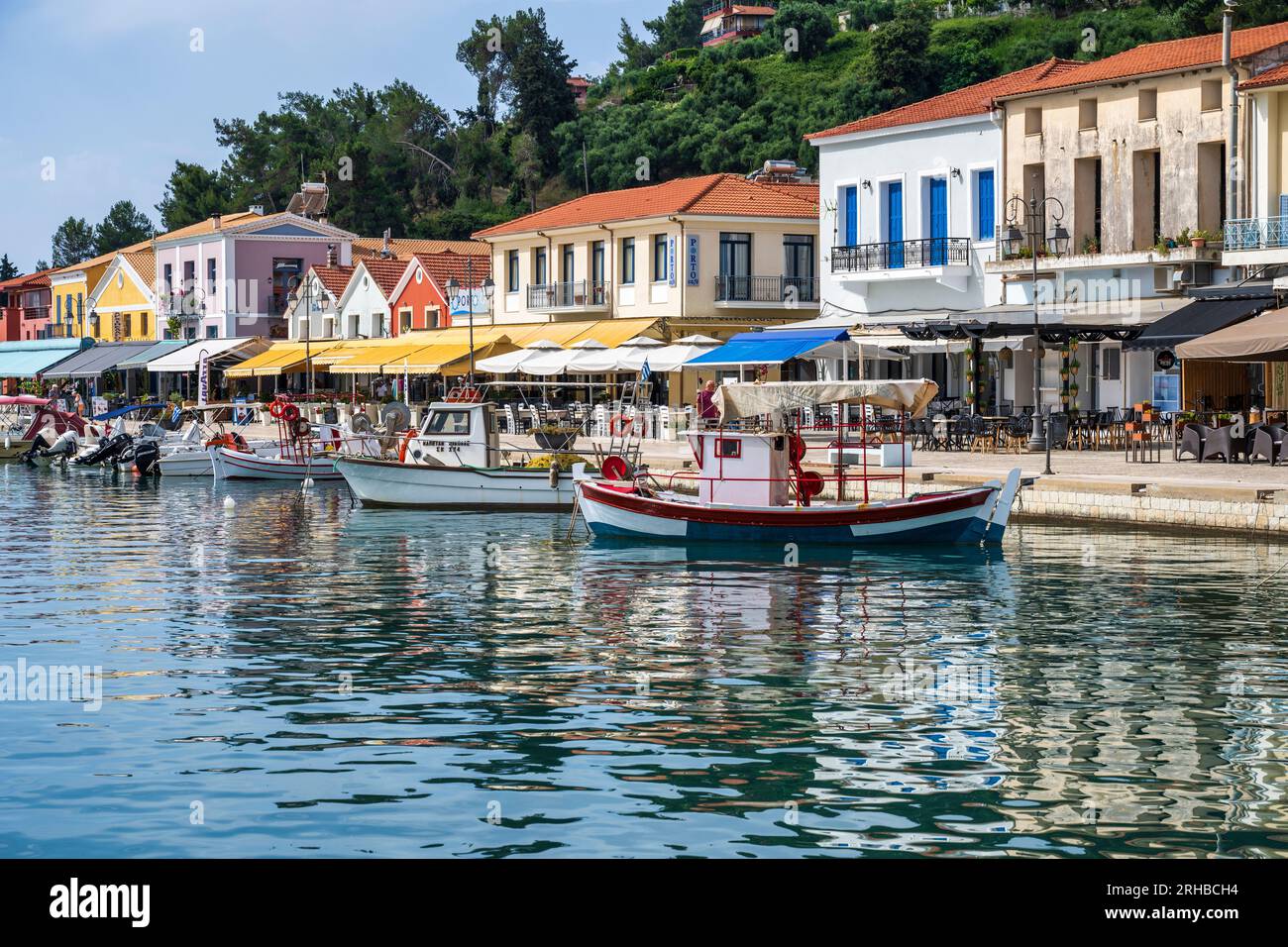 Colourful fishing boats tied up in the harbour of picturesque port town ...