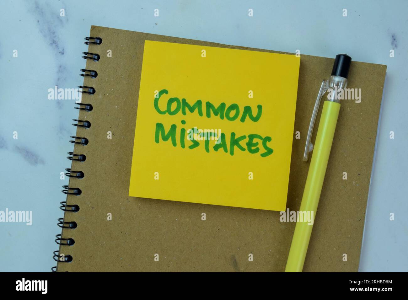 Concept of Common Mistakes write on sticky notes isolated on Wooden ...