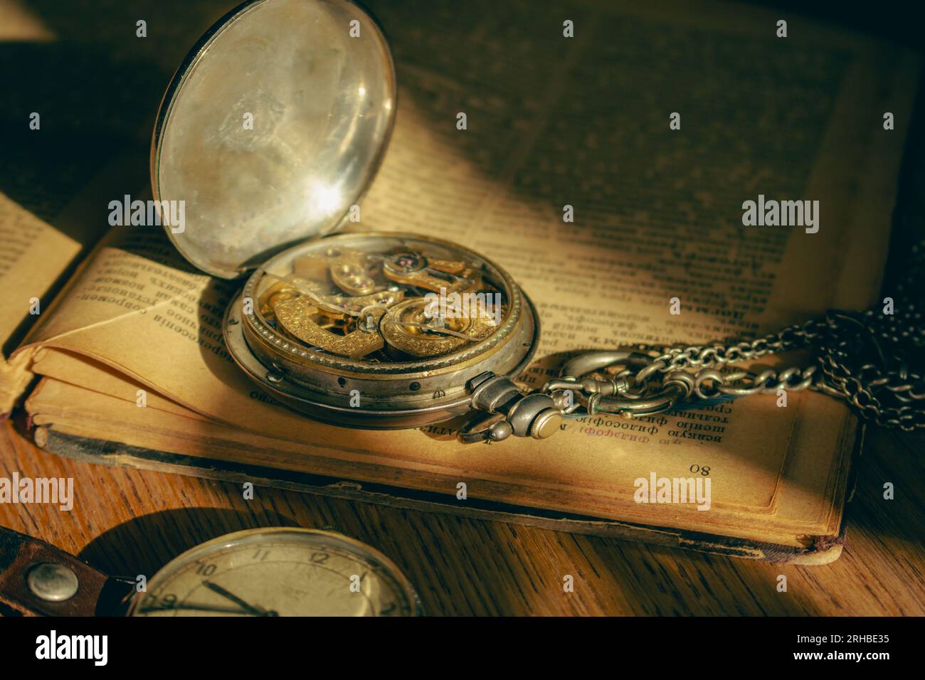 Antique pocket watch and ancient open book. Retro style objects ...