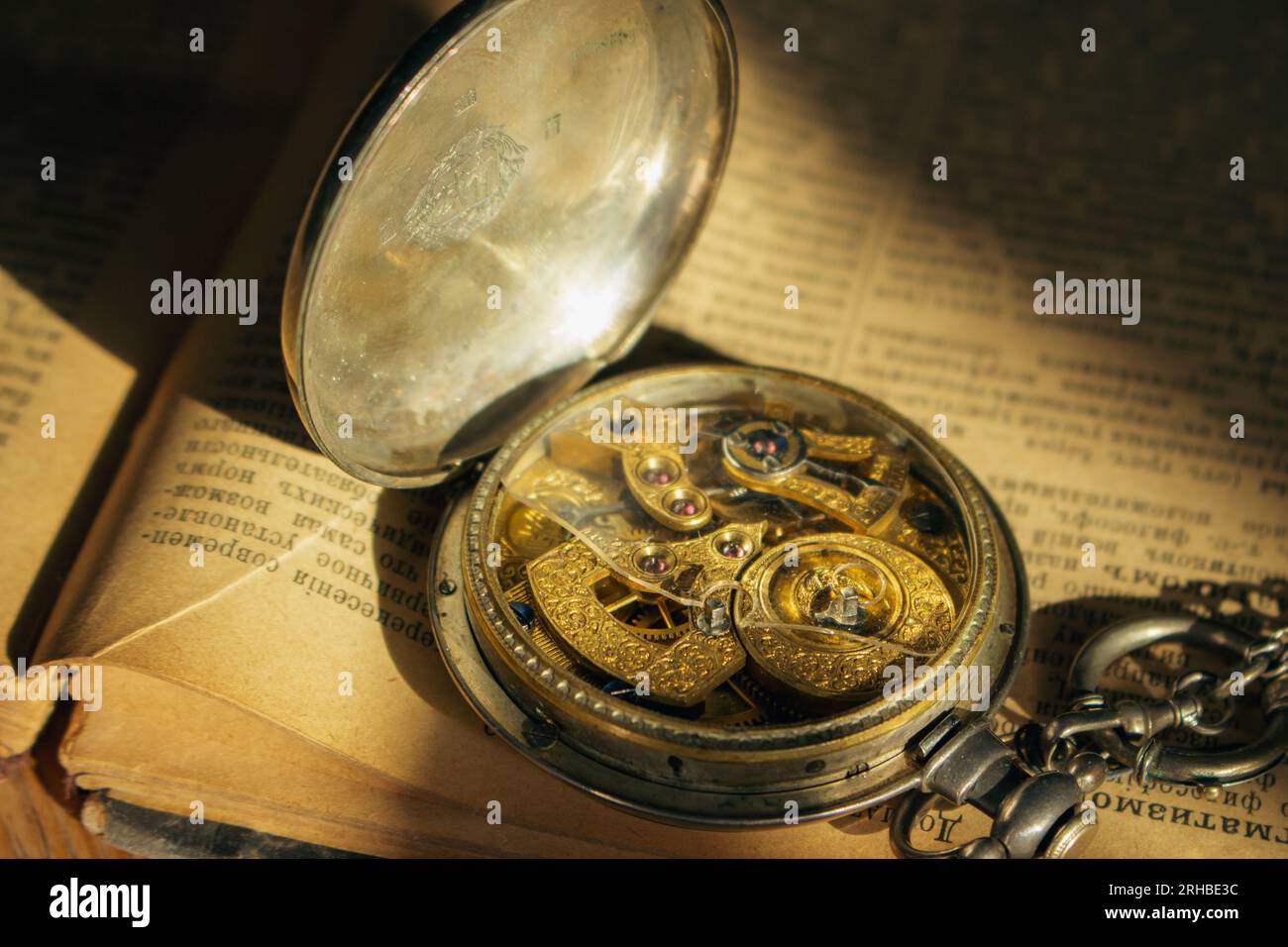 Antique pocket watch and ancient open book. Retro style objects ...