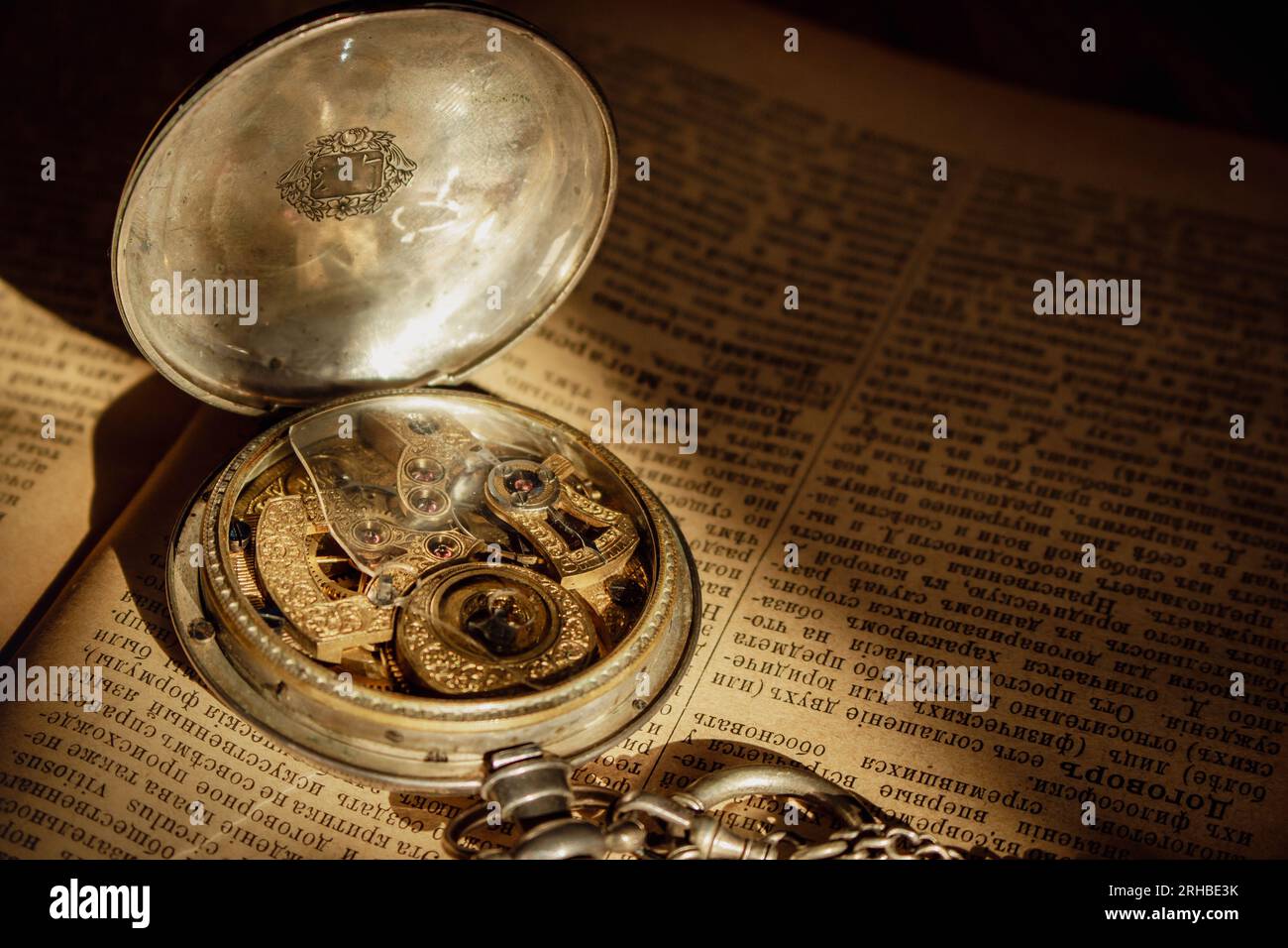 Antique pocket watch and ancient open book. Retro style objects ...