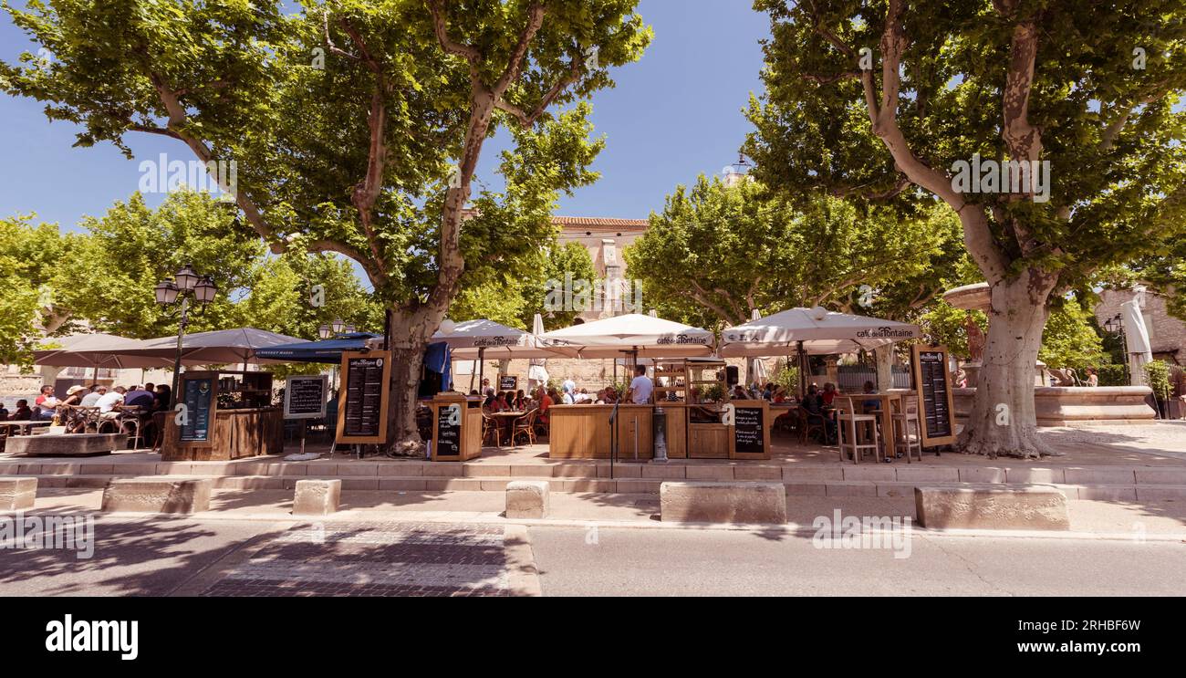 Village square with fountain and restaurant of Maussane les Alpilles ...