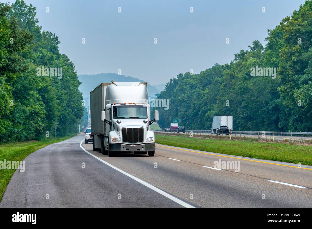 Horizontal shot of a white eighteen wheeler on an interstate with room ...
