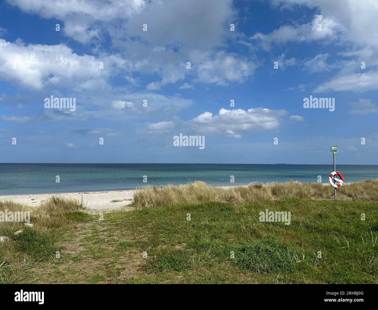 Life preserver on an empty beach between Maarup and Nordby Samsoe ...