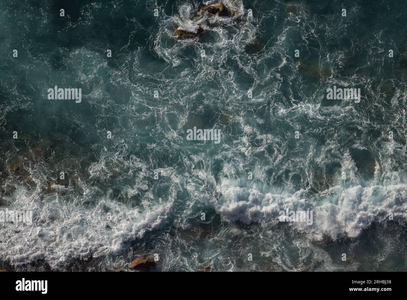 Great waves in the Atlantic Ocean that are illuminated by the sun and ...