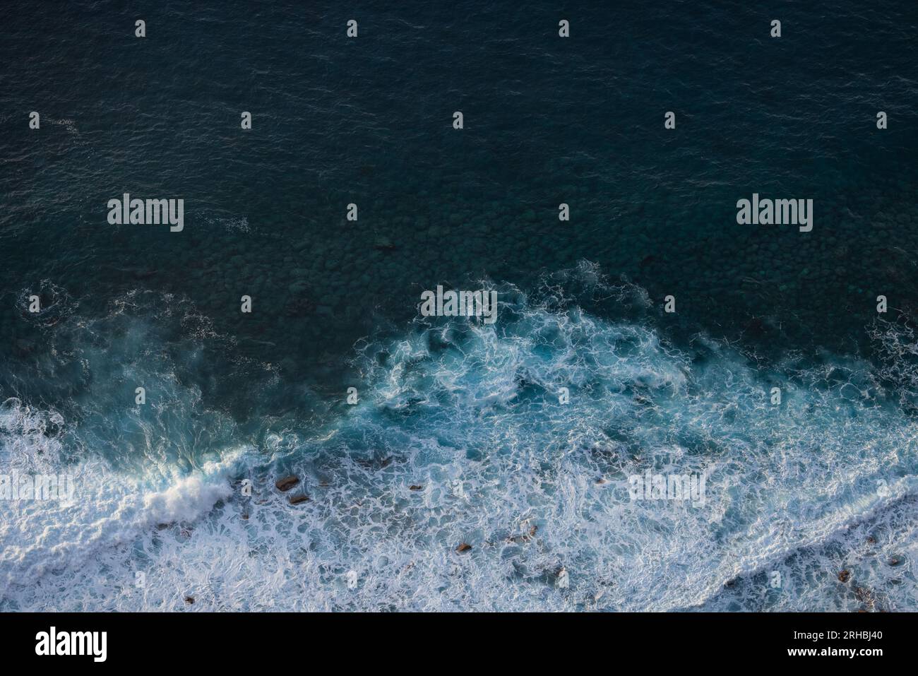 Great waves in the Atlantic Ocean that are illuminated by the sun and ...