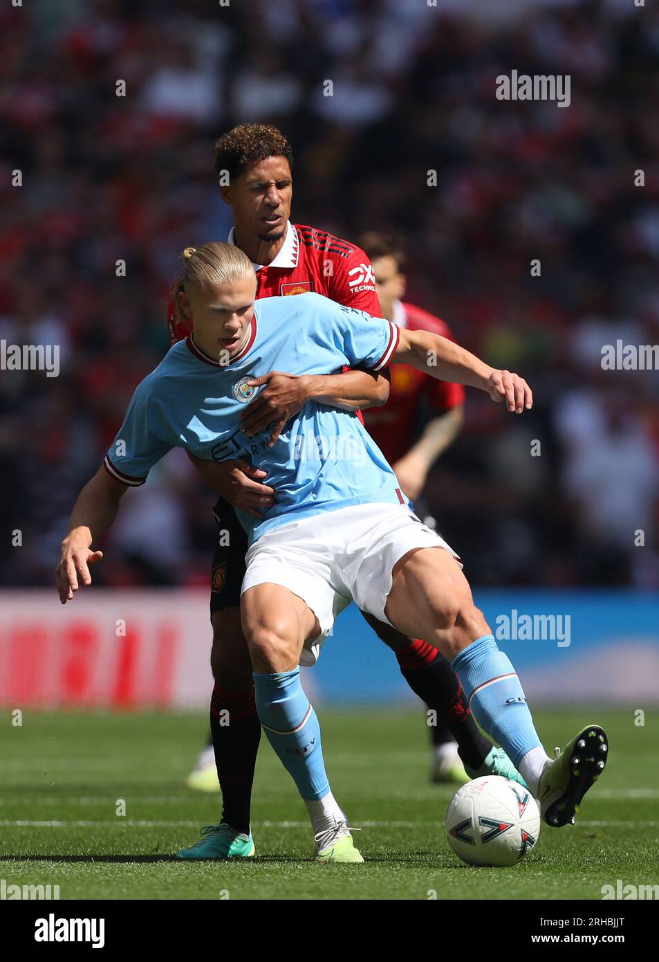 Erling Haaland of Manchester City battles with Raphael Varane of ...
