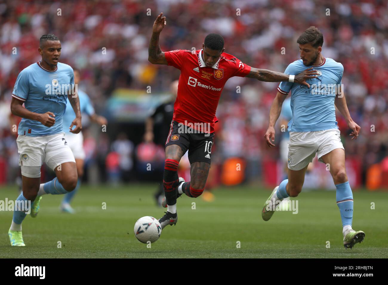 Marcus Rashford of Manchester United holds off Ruben Dias of Manchester ...