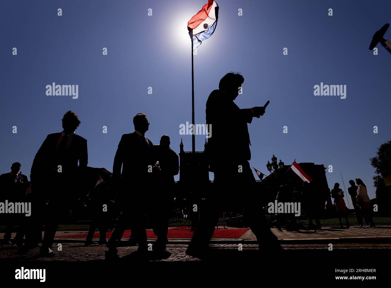 15 August 2023, Paraguay, Asunción: People walk past the government ...