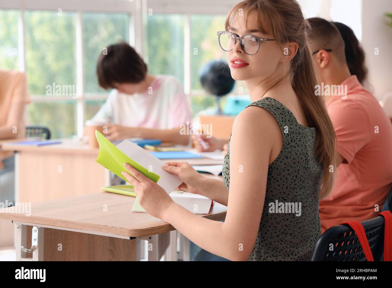 Female student with her classmates having lesson in classroom Stock ...