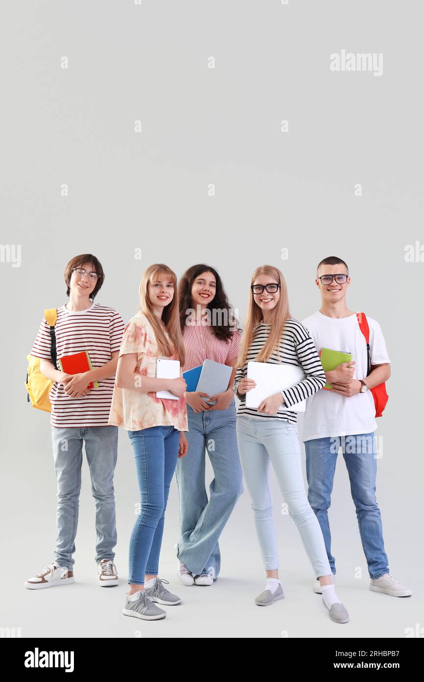 Group of students on light background Stock Photo - Alamy