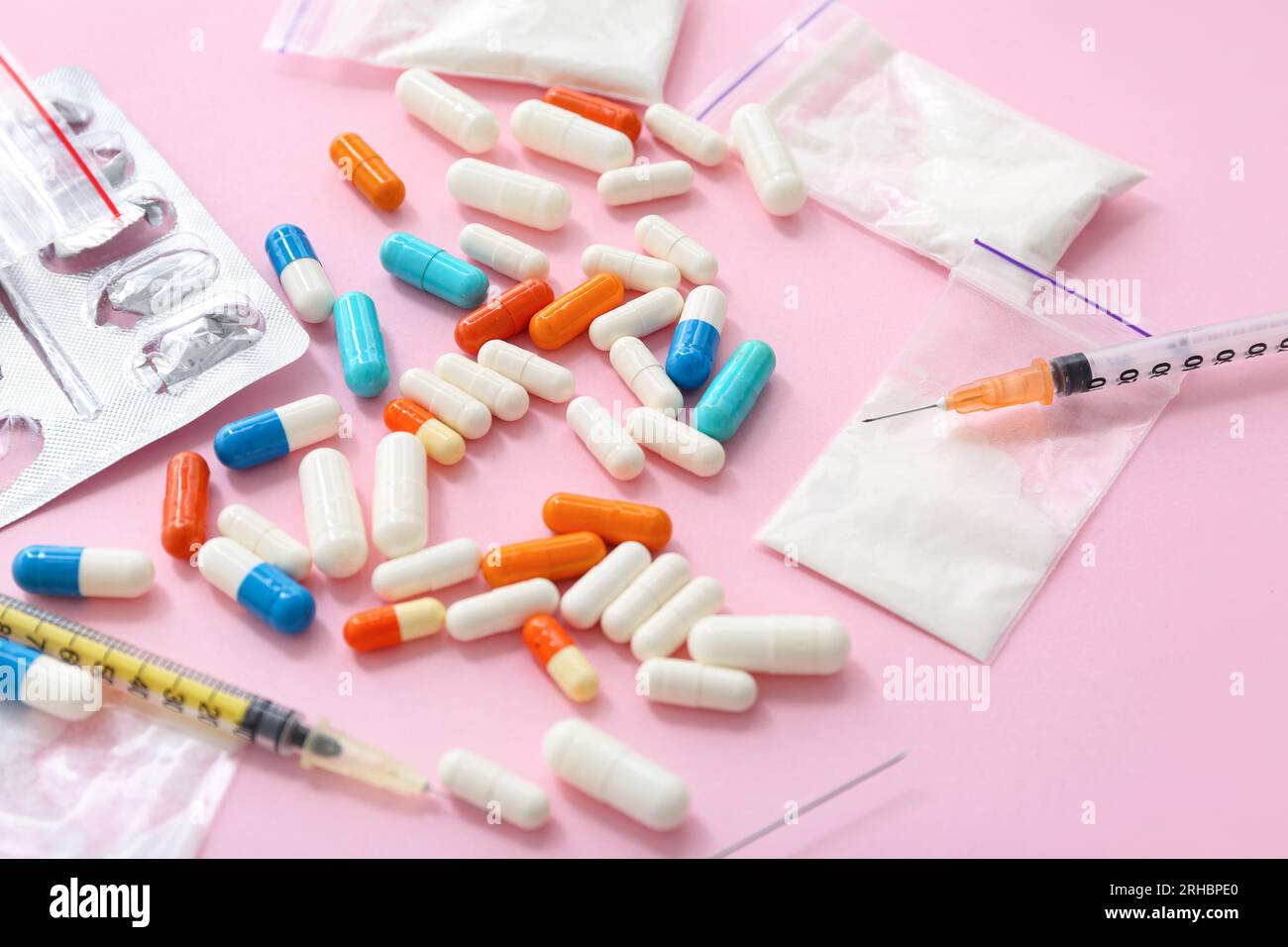 Different drugs and syringes on pink background Stock Photo - Alamy
