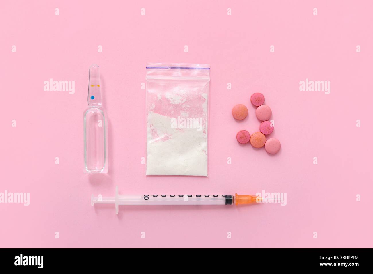 Composition with drugs and syringe on pink background Stock Photo - Alamy